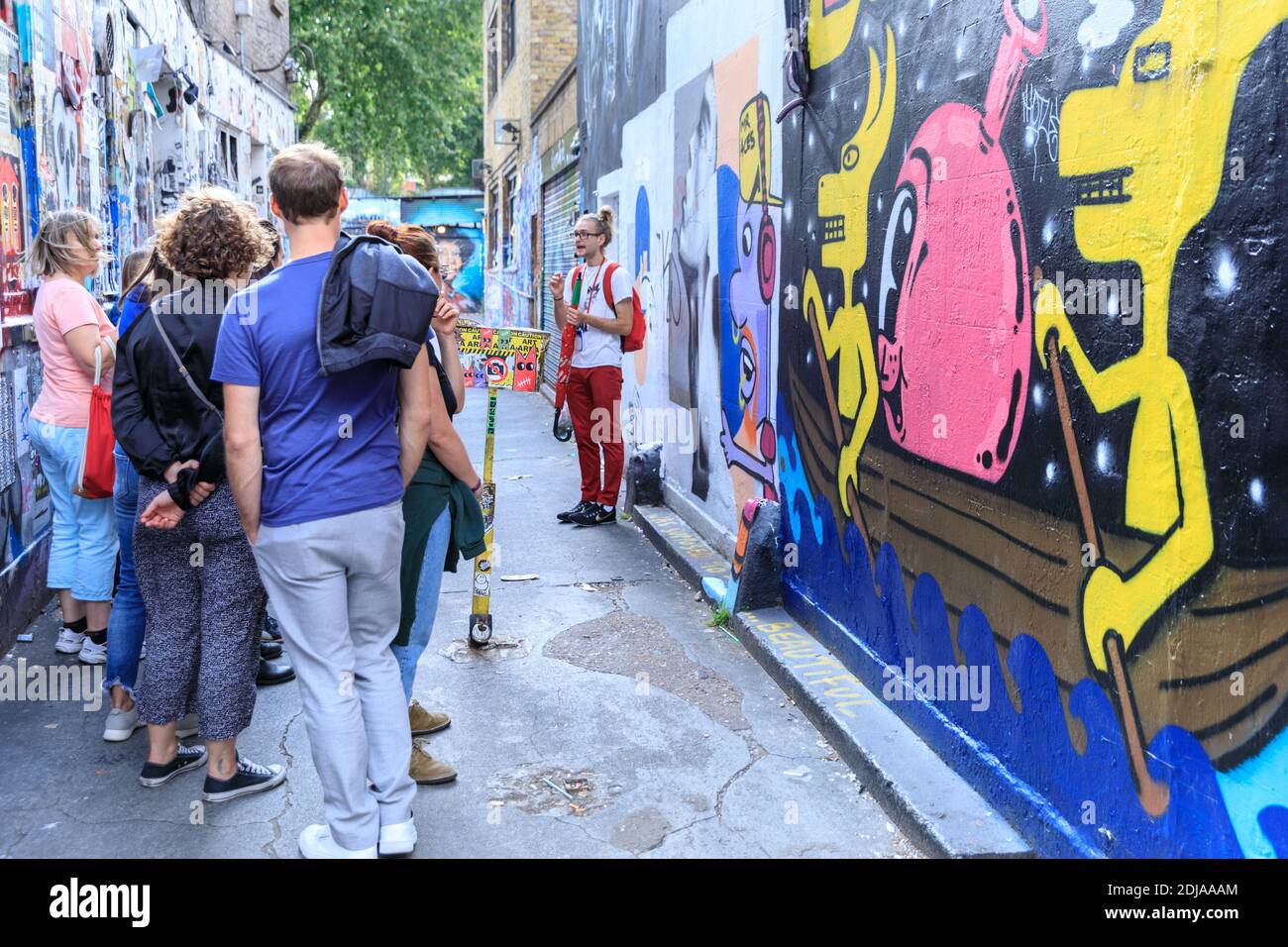 People on walking tour of Brick Lane murals and street art in the East ...
