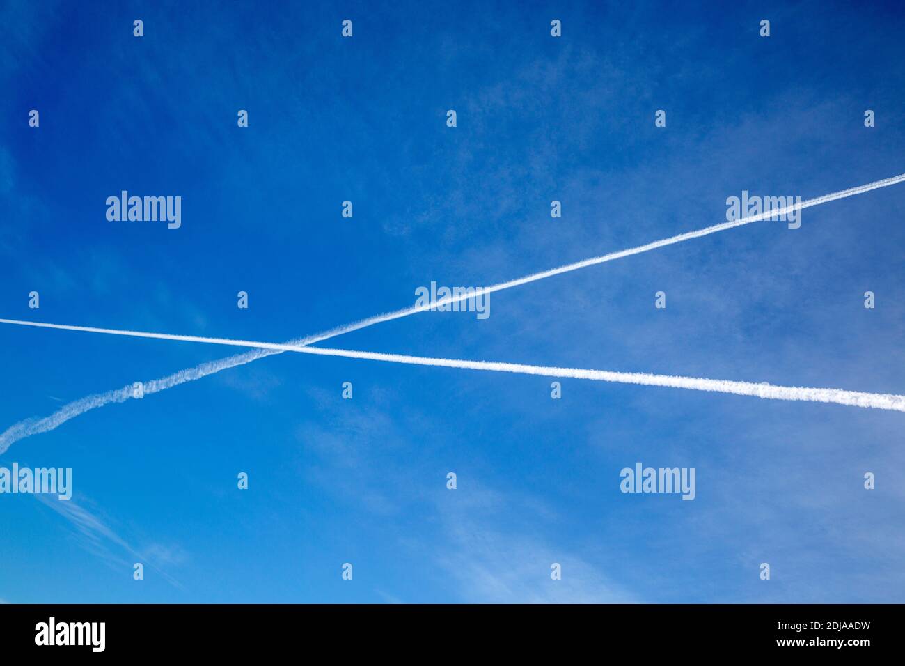 Two aeroplane contrails crossing each other in deep blue sky Stock ...