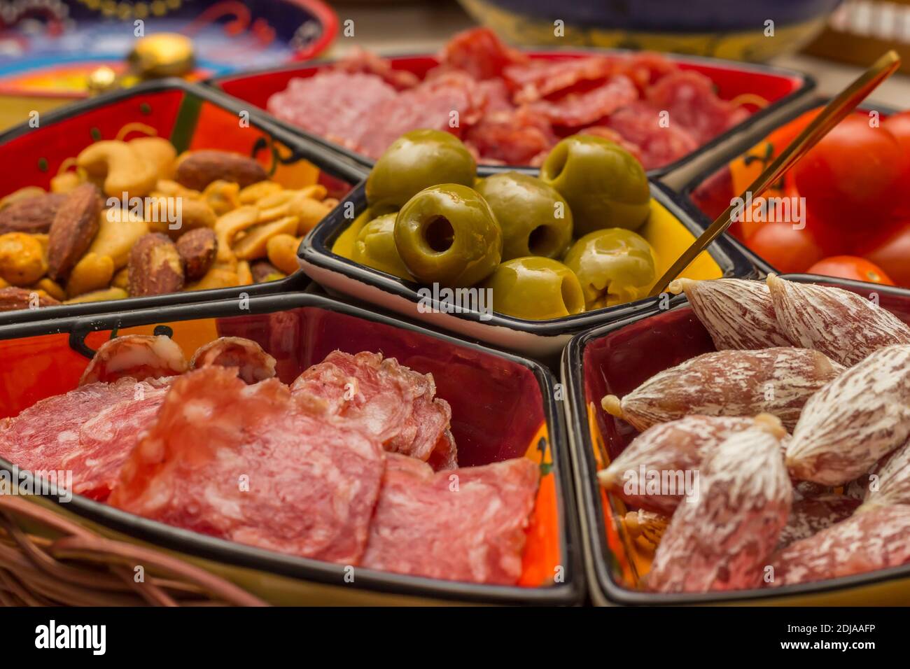 Traditional spanish tapas dish with olives, chorizo, nuts and fuet ...