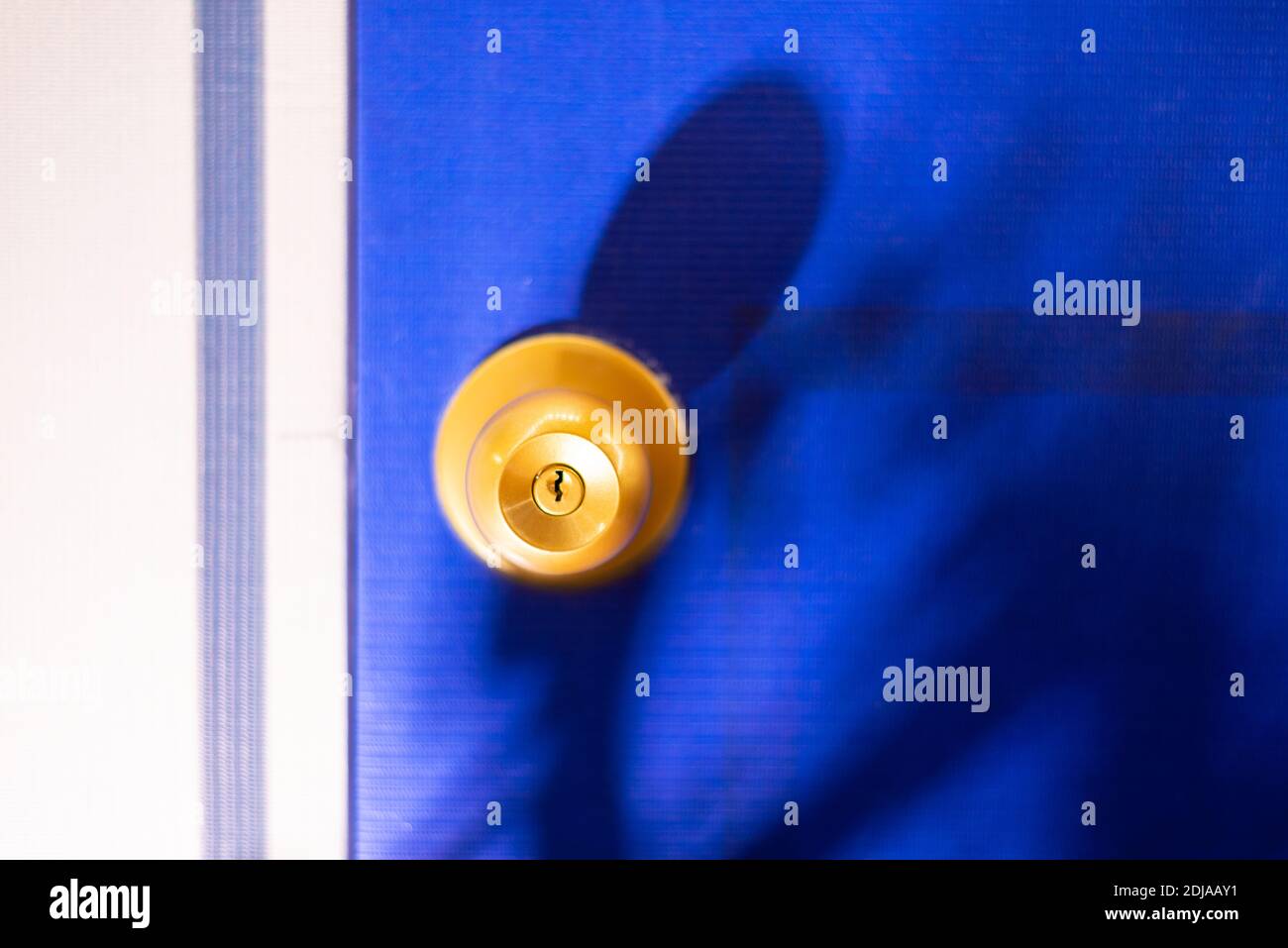 Gold lock on blue door. Shadow and highlight Stock Photo - Alamy