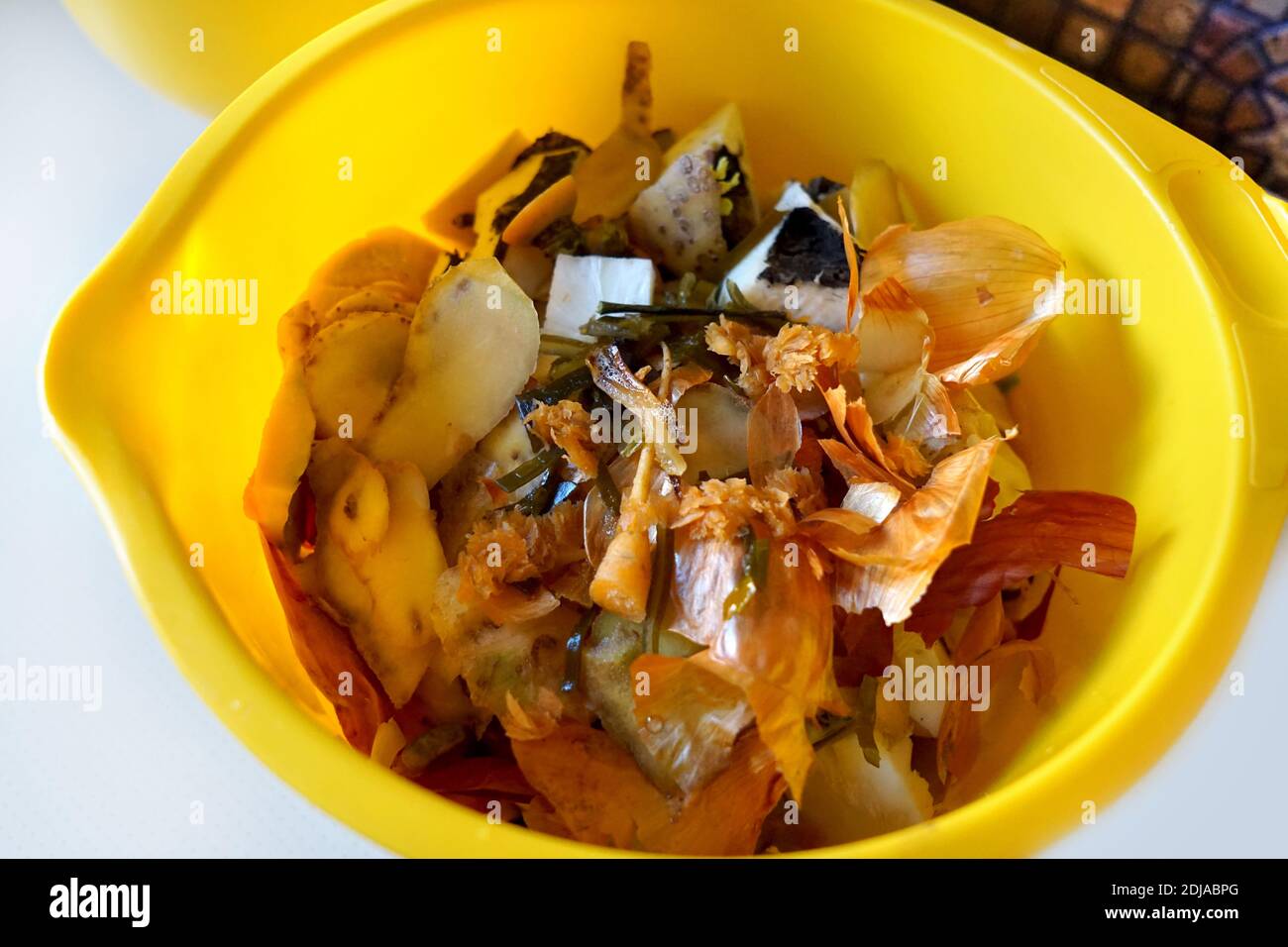 Vegetable compost in a yellow bowl on a white table Stock Photo - Alamy