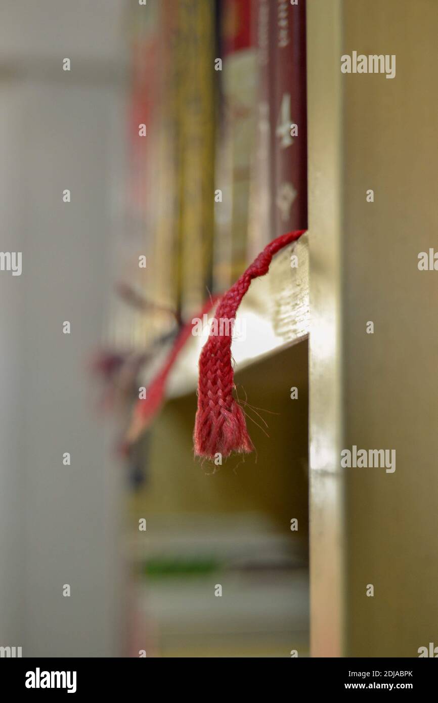 Library rows with books and red colored bookmarks. Close up photo Stock ...
