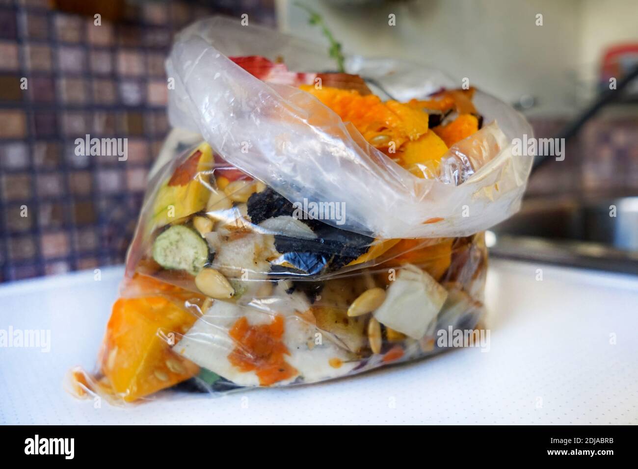 Compost of vegetables in a transparent plastic bag close-up. Eco life ...