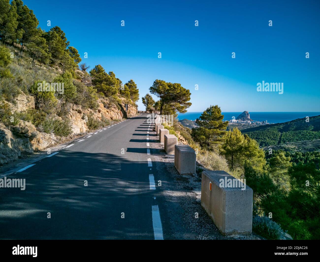 Mountain road with protection bollards near ifach boulder Stock Photo ...