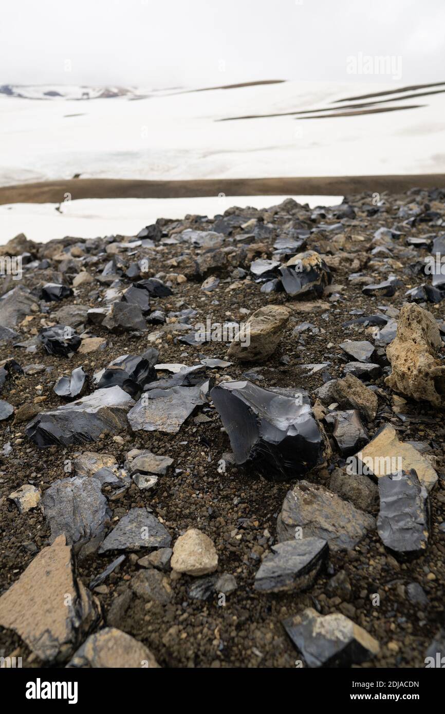 Obsidian volcanic glass scattered on the path of Laugavegur hike in the ...