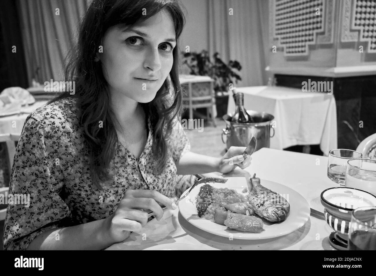 Woman fish eating Black and White Stock Photos & Images - Alamy