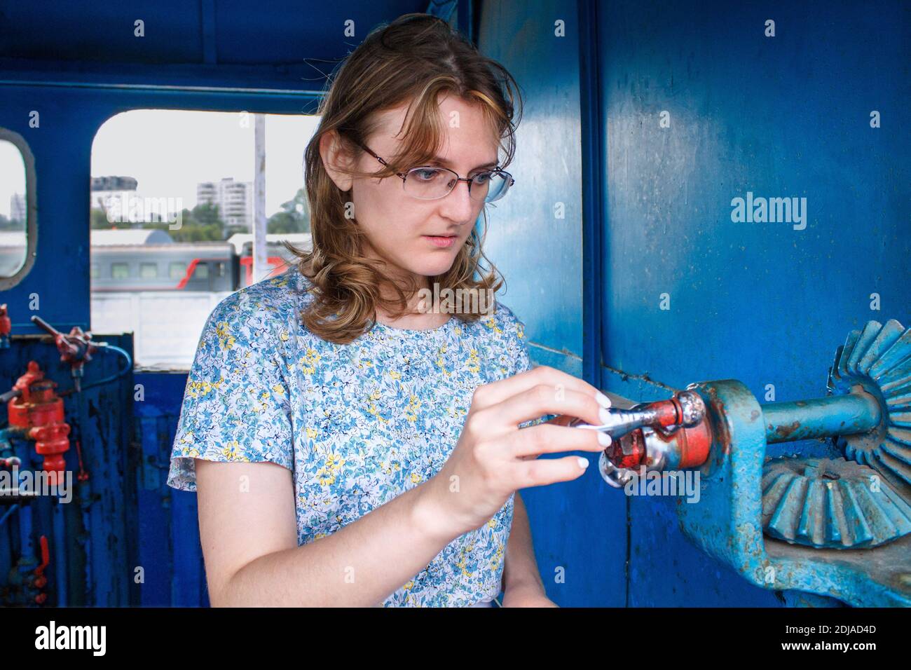A woman's hand turns the detail of the steam locomotive. Female ...