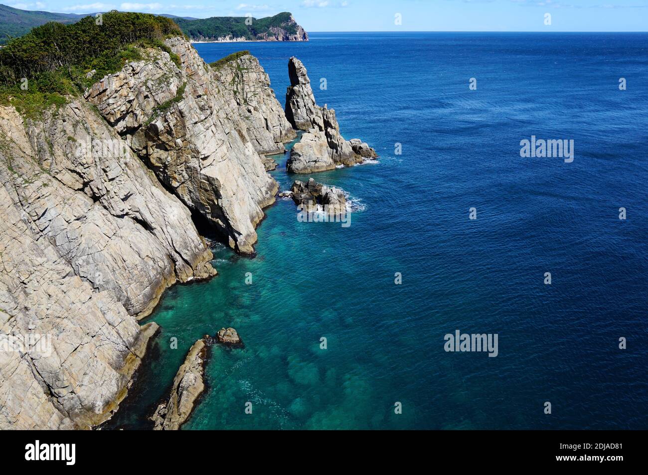 Blue sea abyss and turquoise reefs in clear water near the shore ...