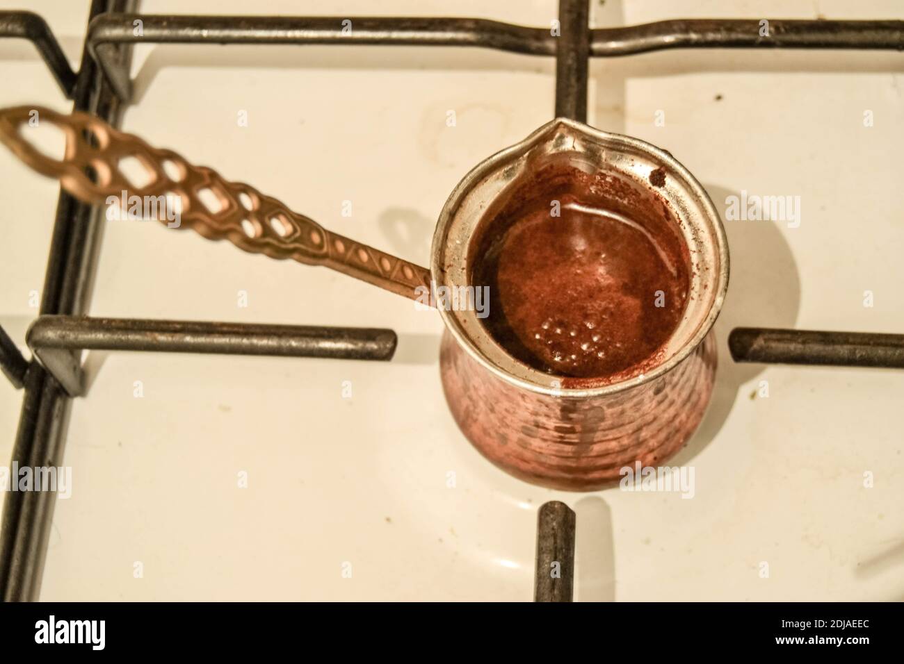 Traditional turkish coffee pot on the kerosene burner or gas oven. It ...