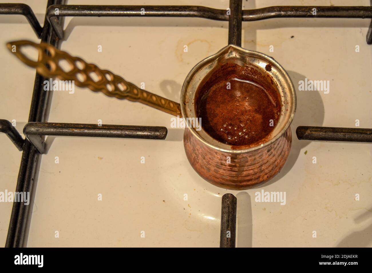 Traditional turkish coffee pot on the kerosene burner or gas oven. It ...
