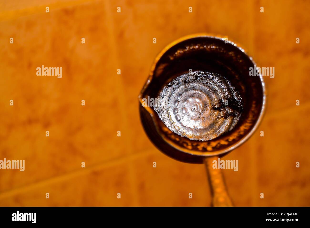 Traditional turkish coffee pot after cooking of caffe. Remains of ...