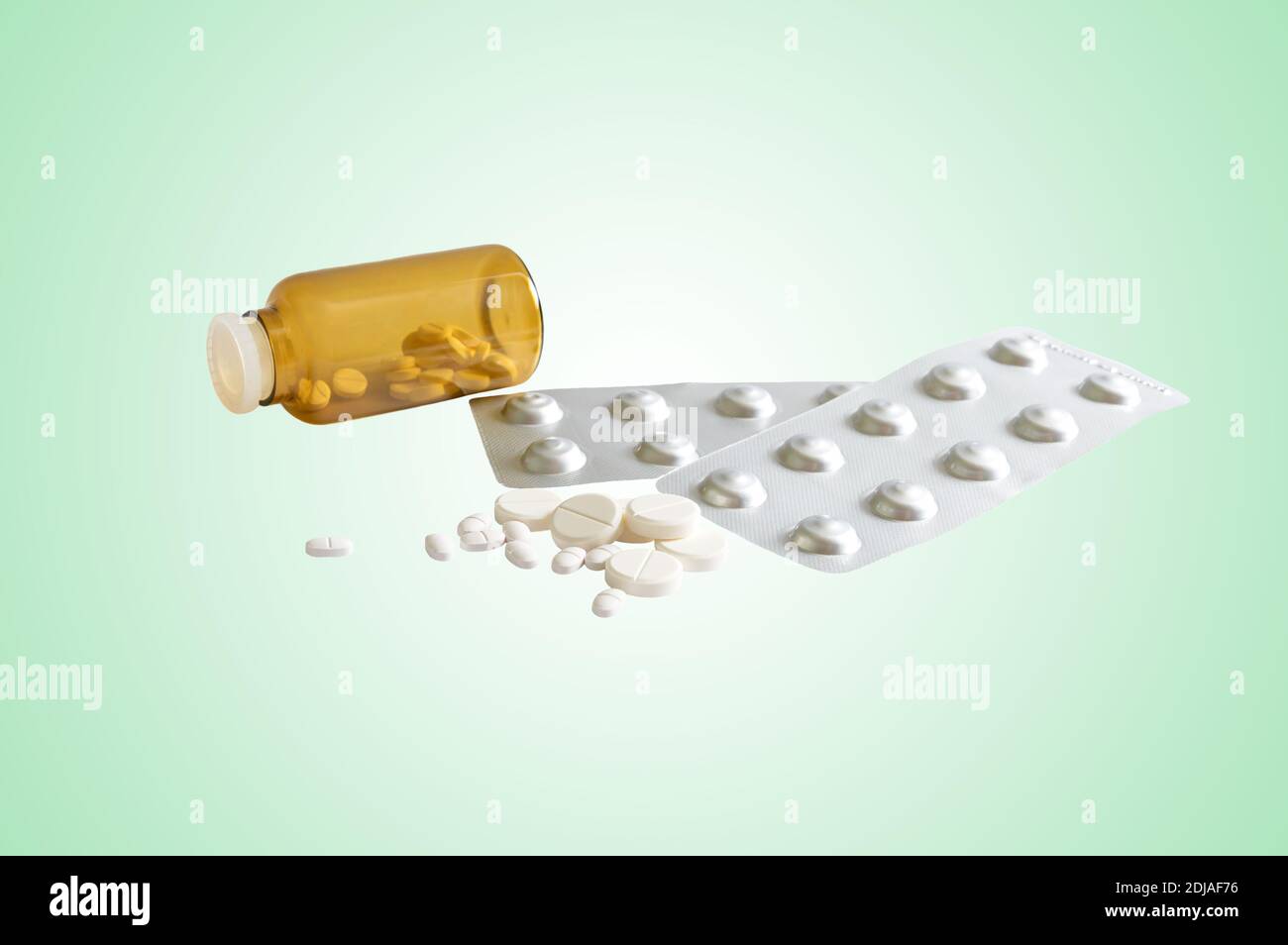 Medical brown pill bottle, scattered tablets, blisters. Assorted ...