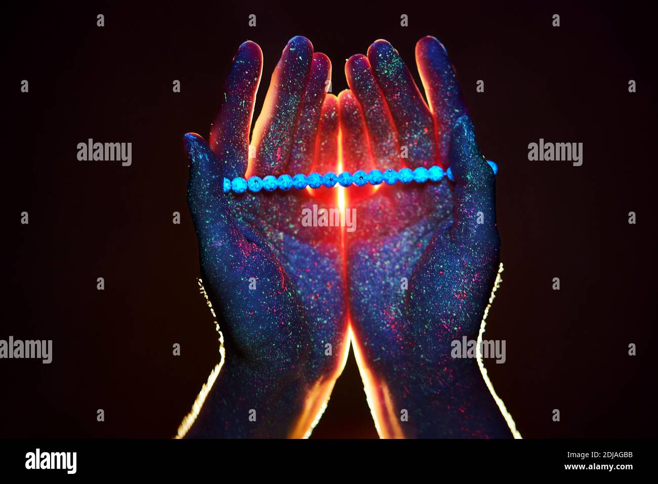 Rosary in hand, prayer. Light through the palms of your hands in ...