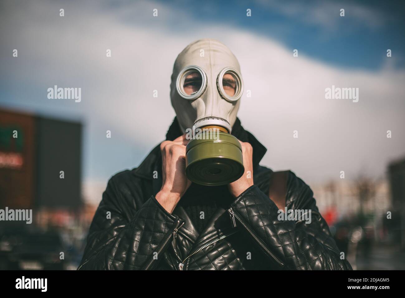 close up. casual guy in a gas mask on a city background Stock Photo - Alamy