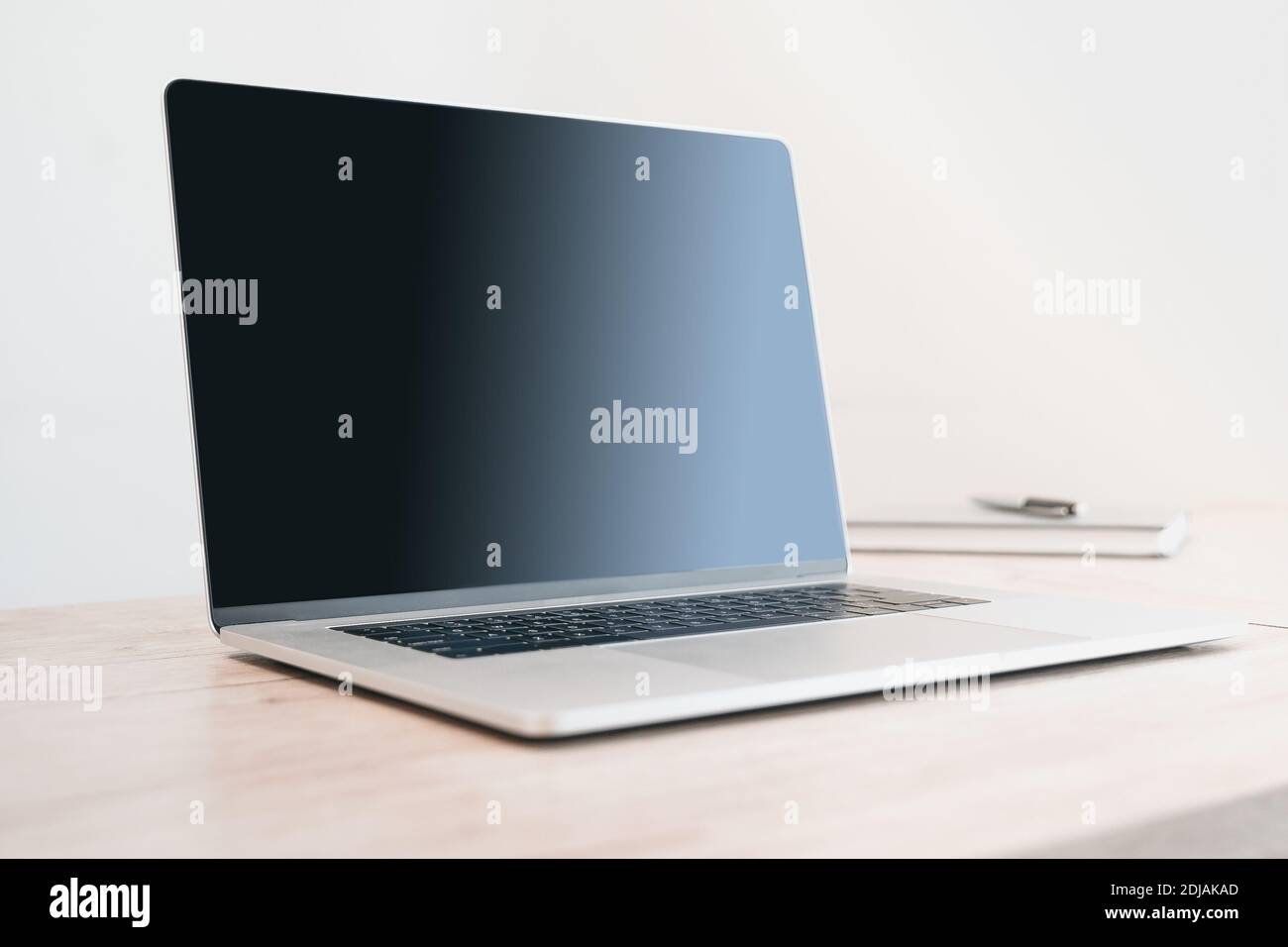side view. open laptop on the desktop Stock Photo - Alamy