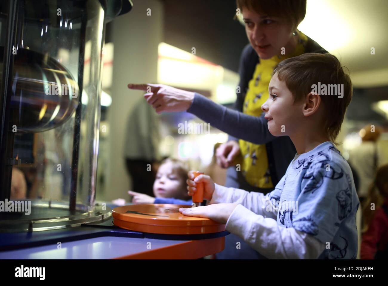 Family doing a physical experiment in laboratory Stock Photo - Alamy