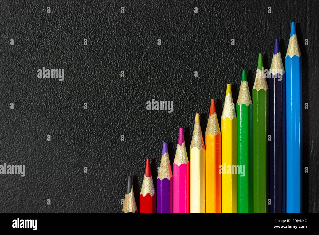 Set of colored pencils on a black background. Colored pencils on a ...
