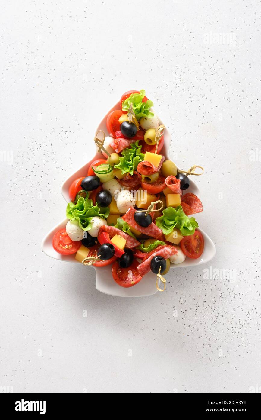 Holiday canapes in plate shaped of Christmas tree for festive Xmas ...