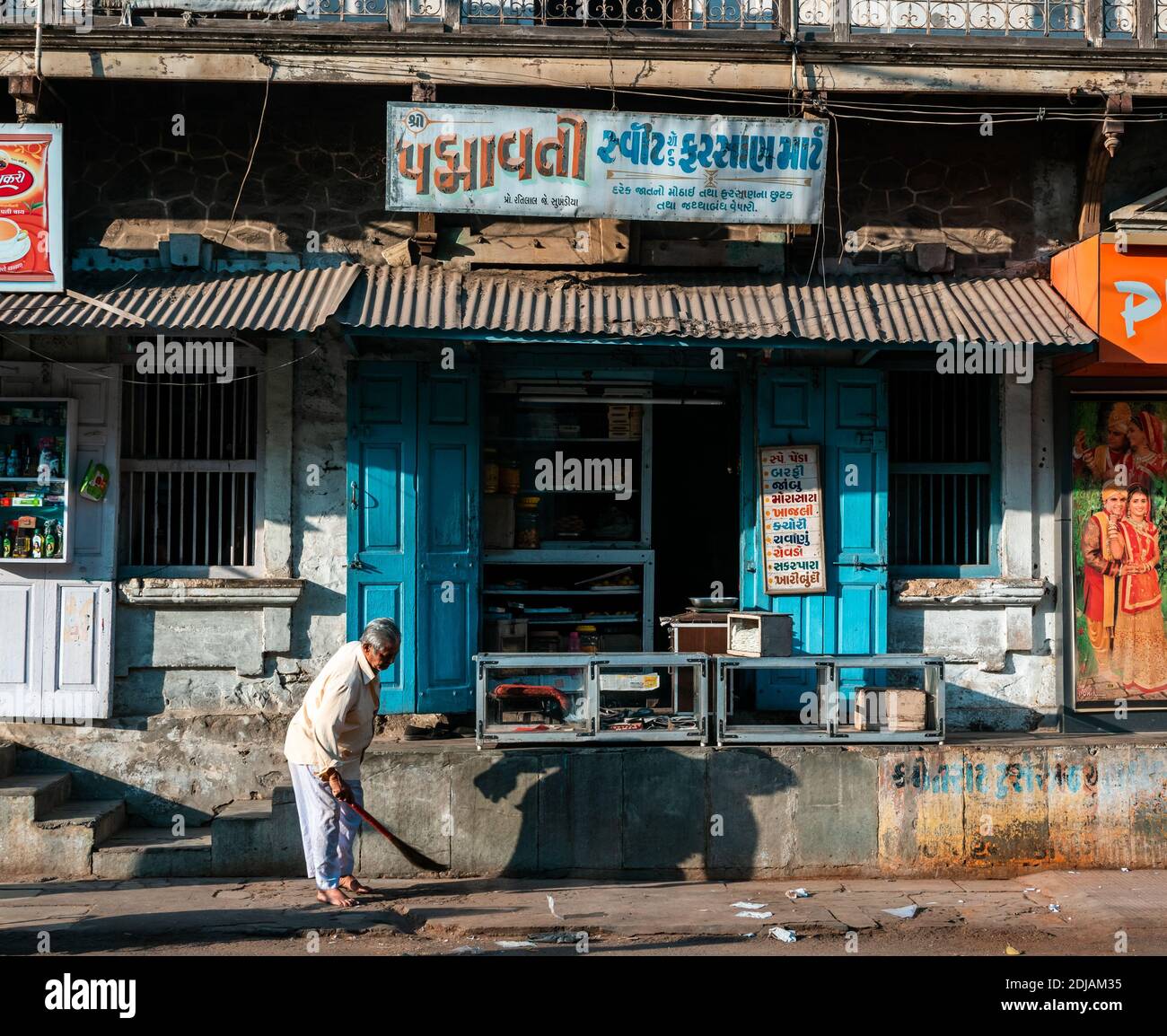 Jamnagar, Gujarat, India December 2018: An elderly Indian man cleaning ...