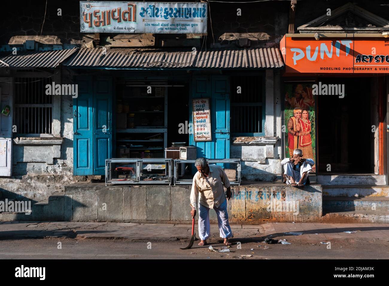 Jamnagar, Gujarat, India December 2018: An elderly Indian man sweeping ...