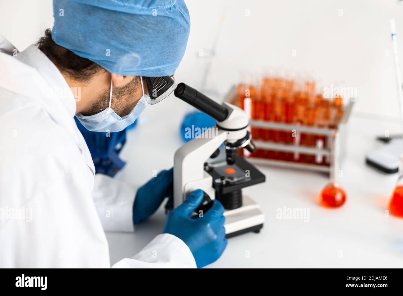 scientist looking at a control sample through a microscope Stock Photo ...