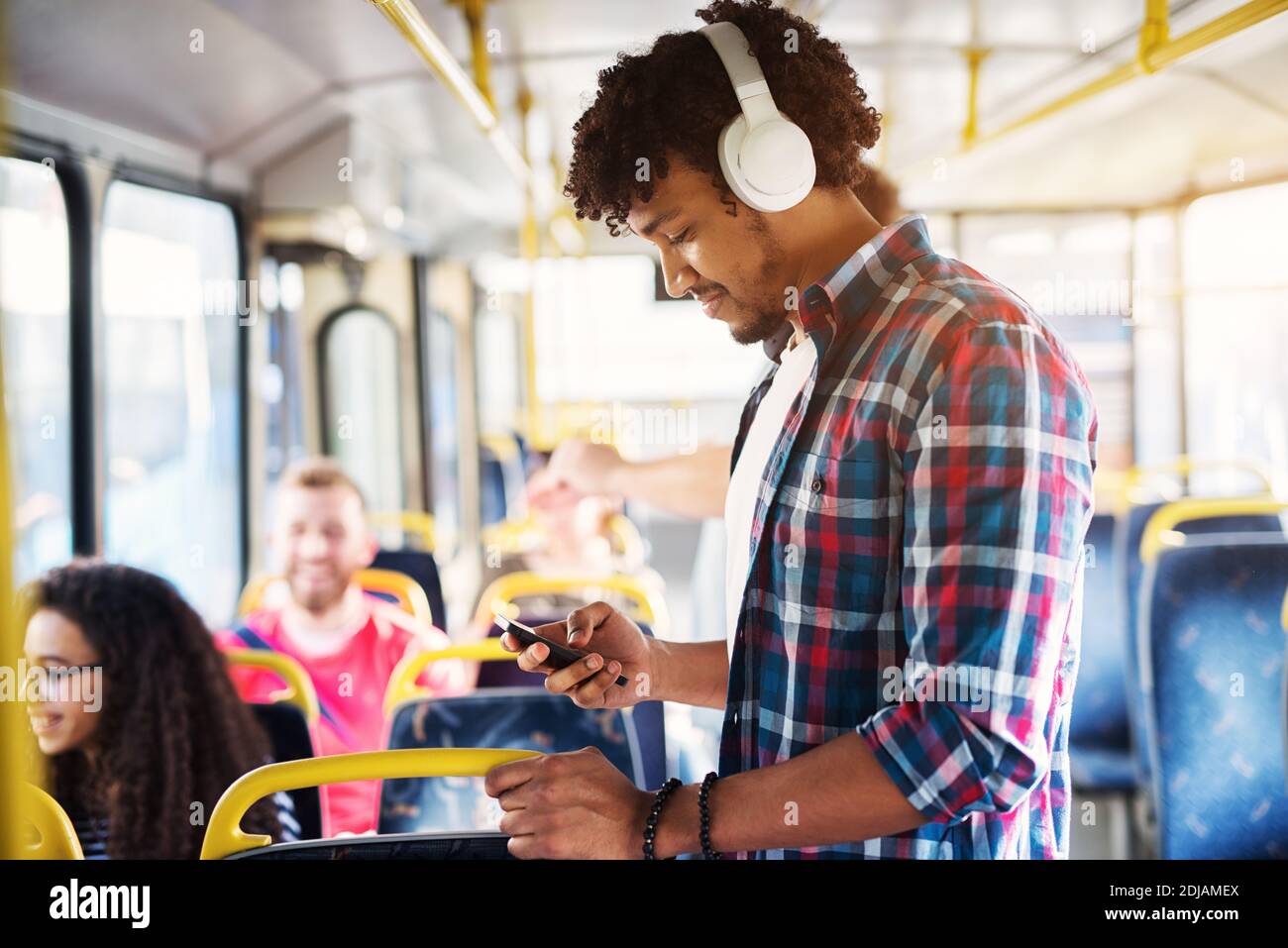 Young handsome man with a headset on is listening to music while ...