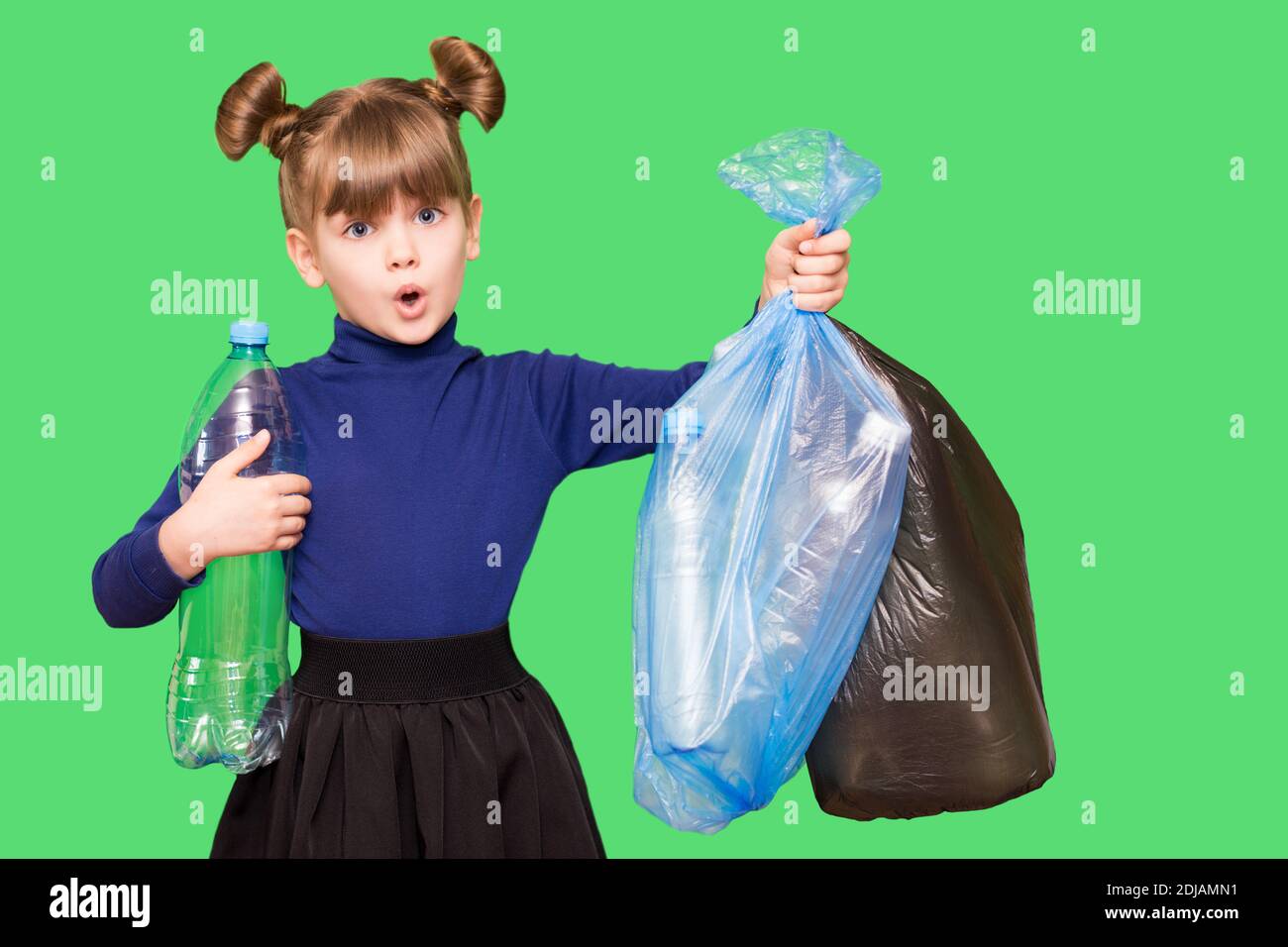Little ecologist girl with confused funny face holding trash bags with ...
