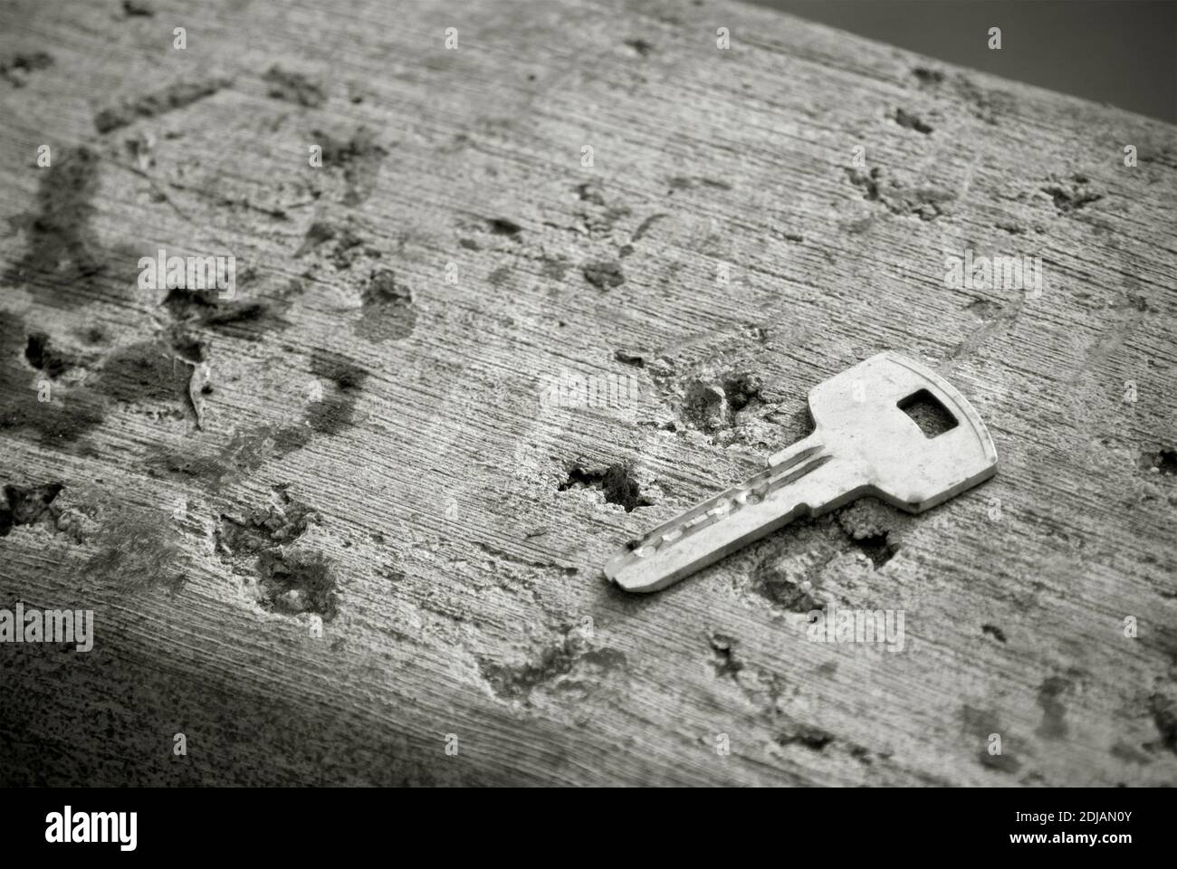 A key on a concrete surface in black and white Stock Photo - Alamy