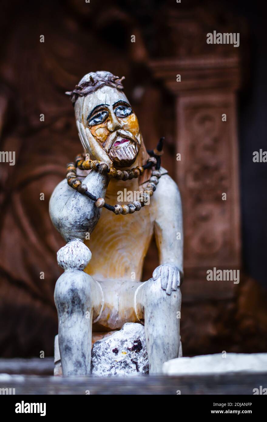 Jesus Christ little wooden statue on wooden background wondering with a ...