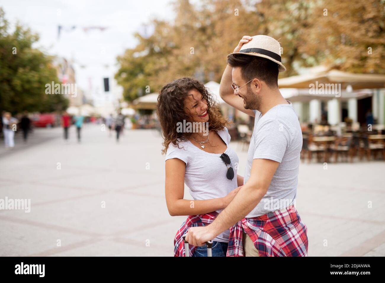 Young adorable couple is laughing on the street while standing on the ...