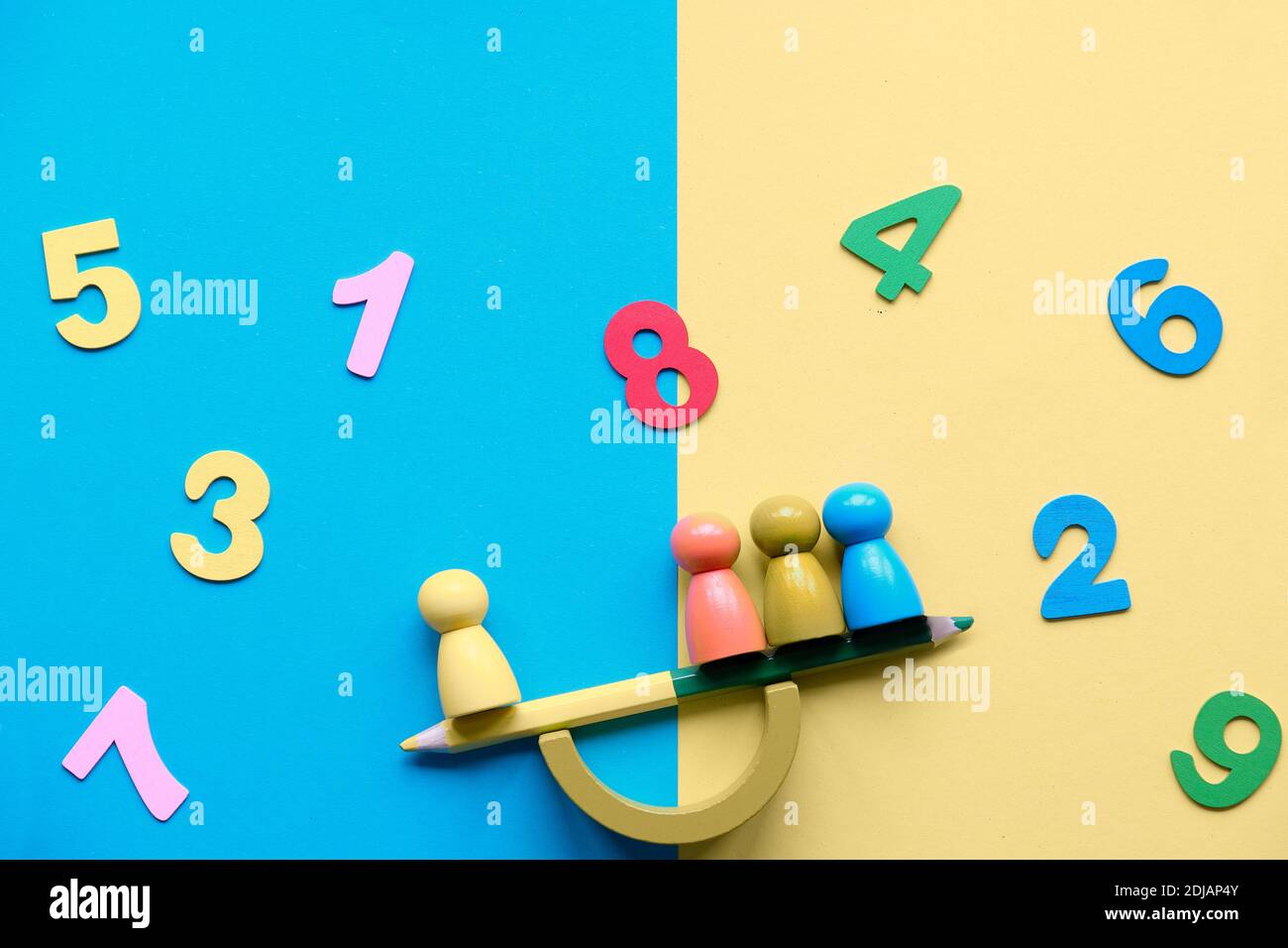 Two figures on a swing on split background, blue yellow paper. Numbers ...