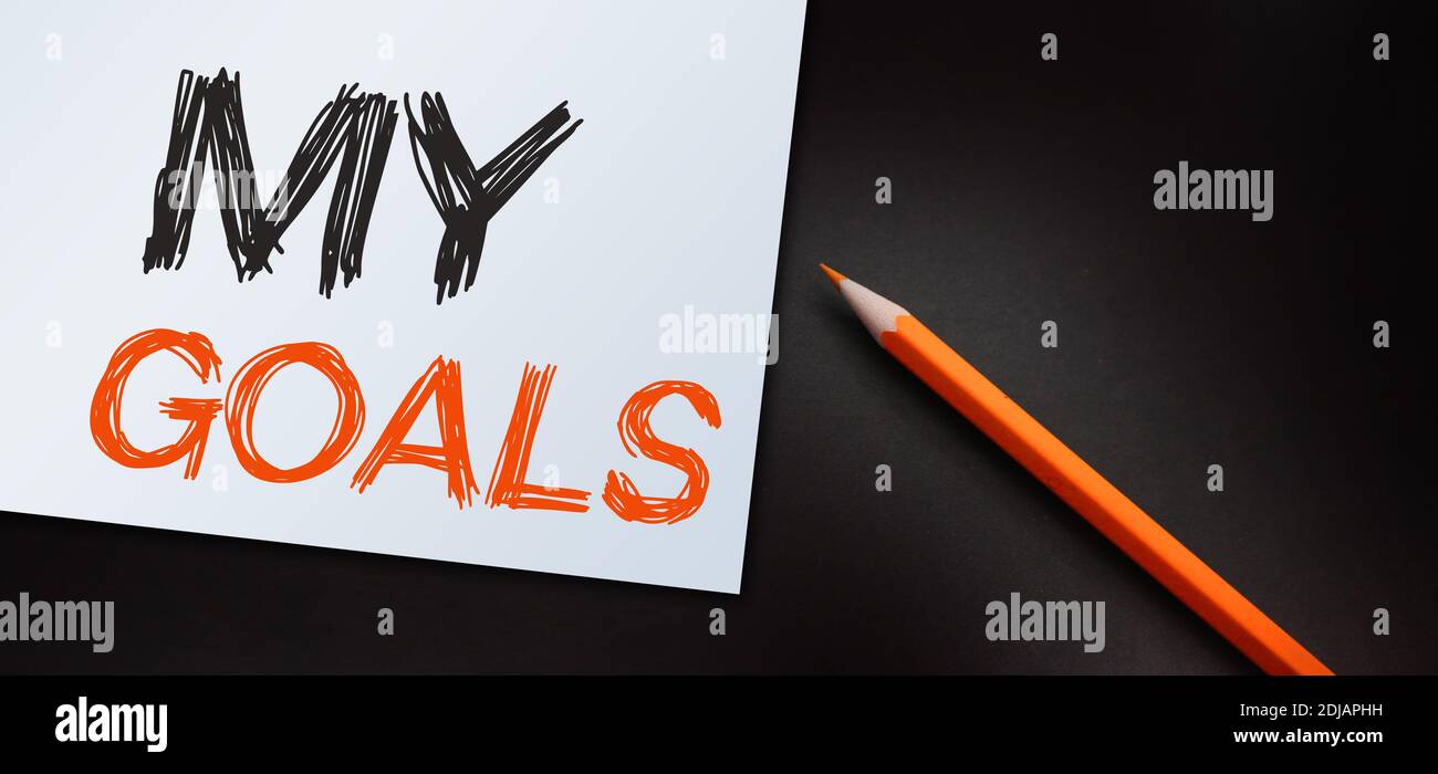 my goals text written on paper and orange pencil. Business and personal ...