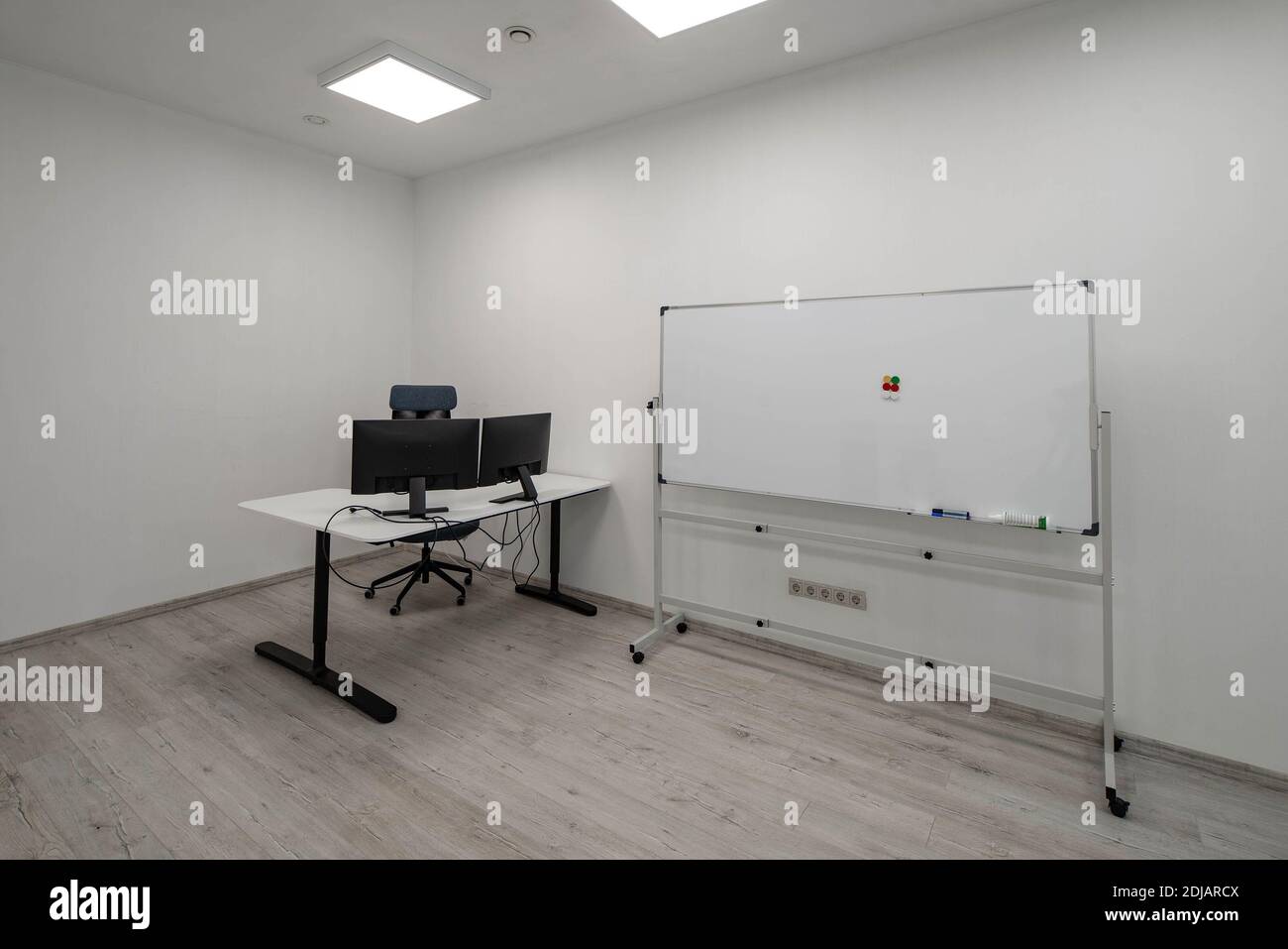 Contemporary white interior of office. Marker board. Computer on table ...