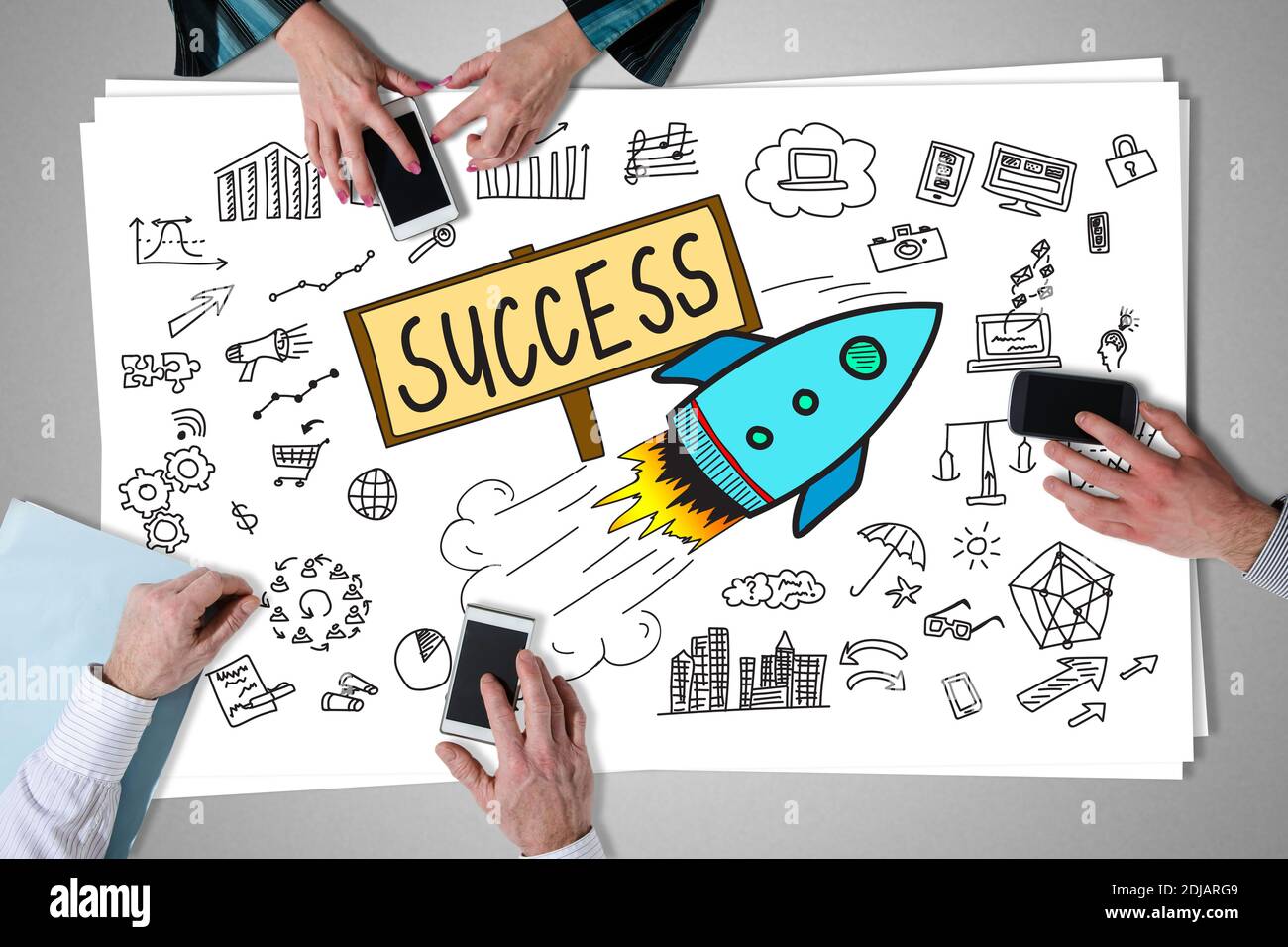 Business success concept placed on a desk with hands using smartphones ...