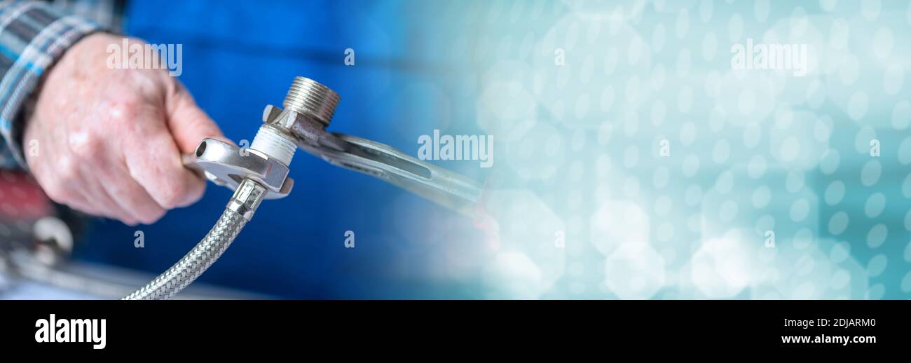 Plumber screwing a plumbing fitting on a pipe. panoramic banner Stock ...
