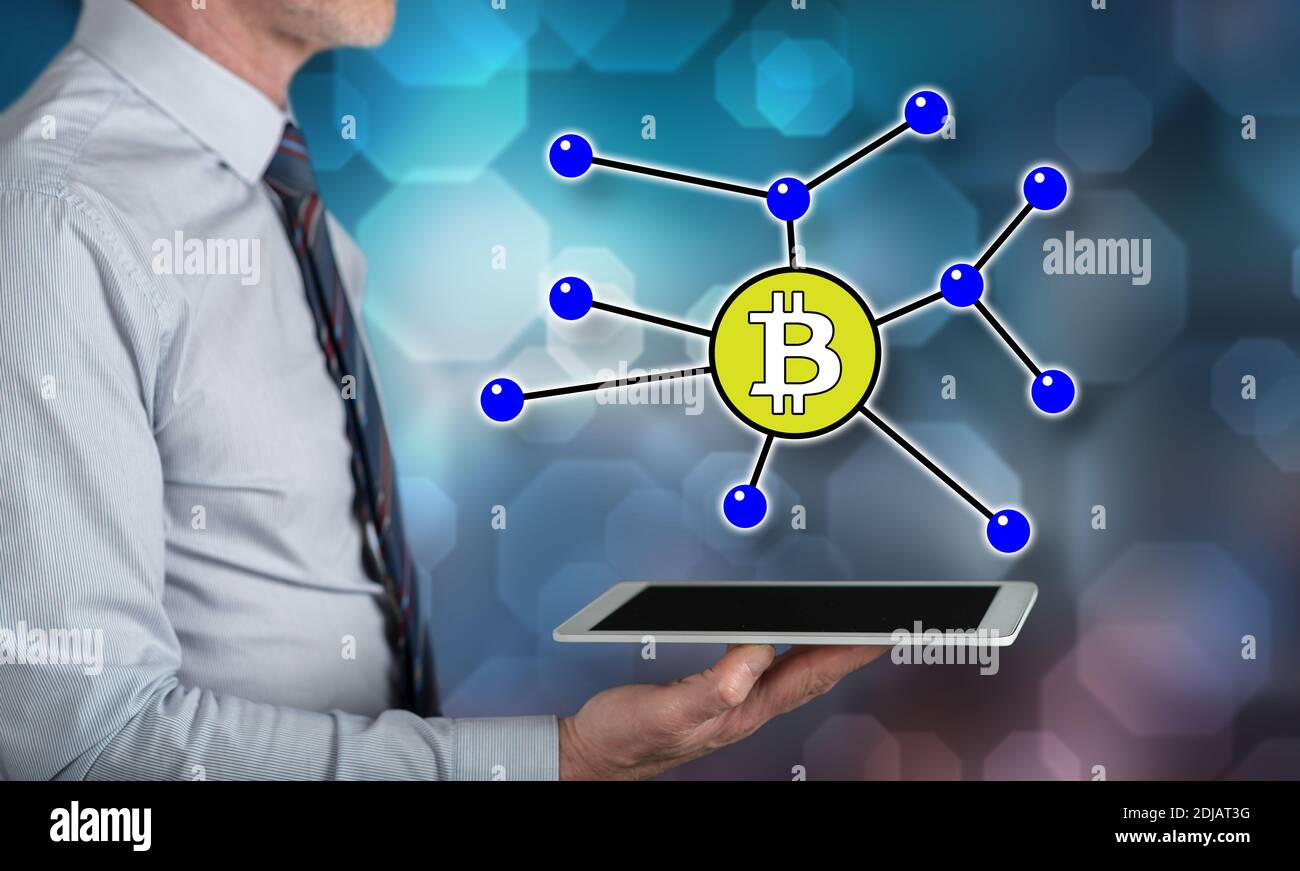 Bitcoin concept above a tablet held by a man Stock Photo - Alamy