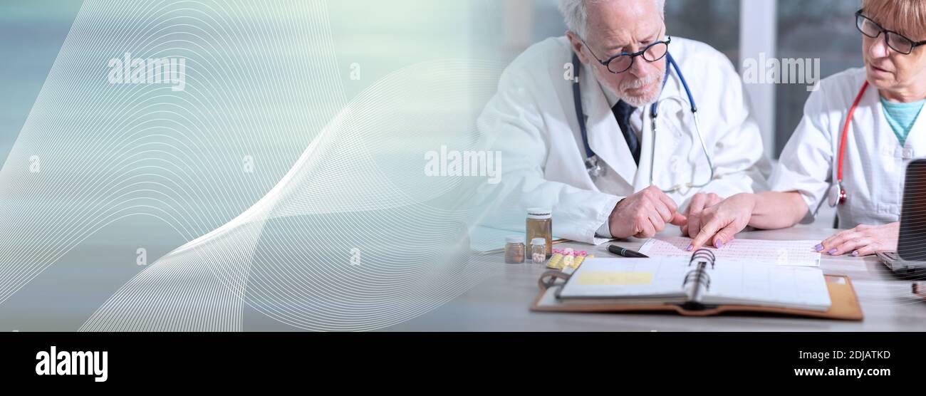 Two doctors discussing about medical results in clinic; panoramic ...