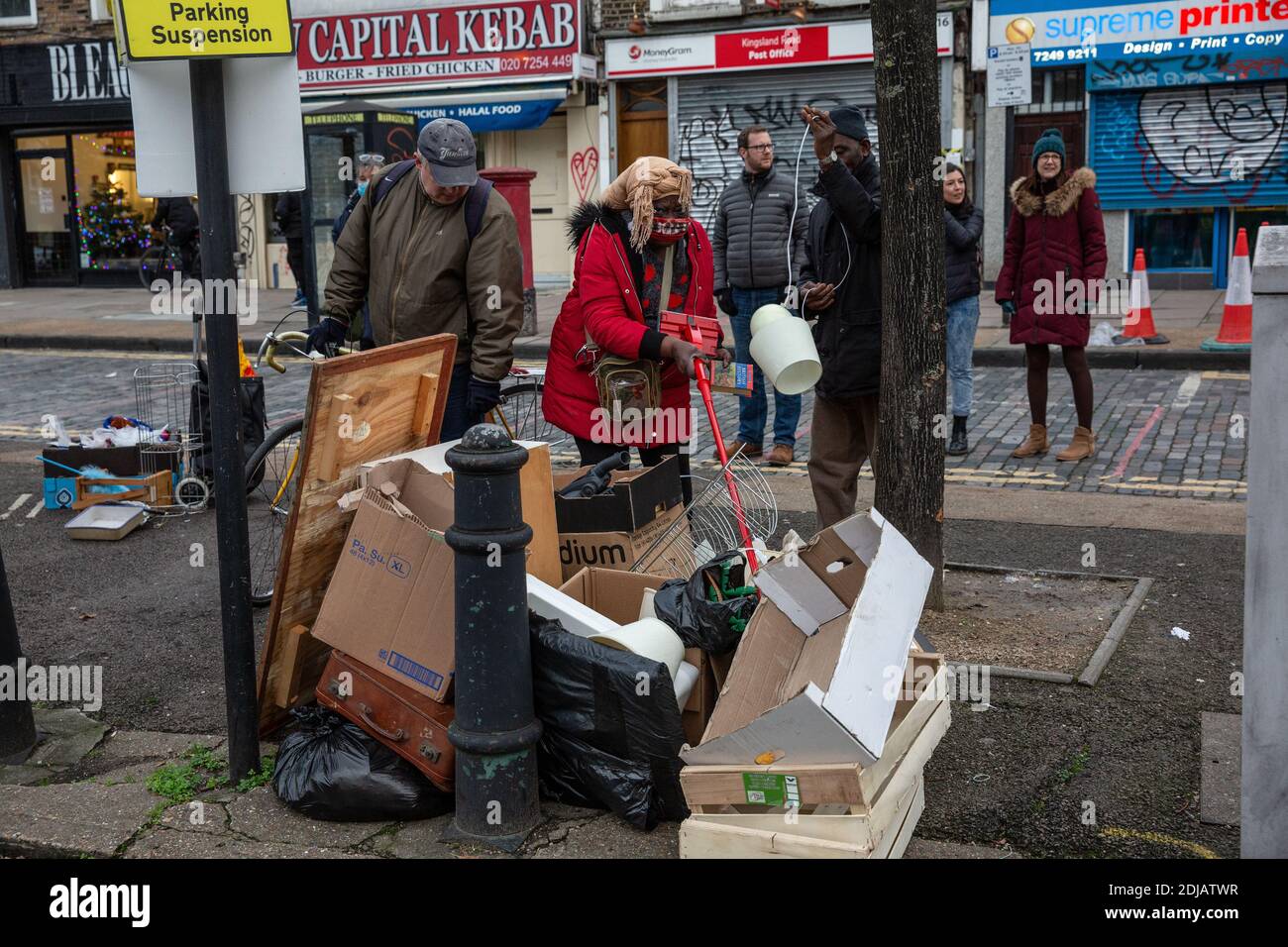 People sort through the remains of a street merchants rubbish left on ...