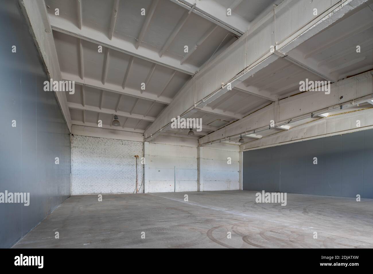 Modern interior of huge empty concrete industrial warehouse. White ...