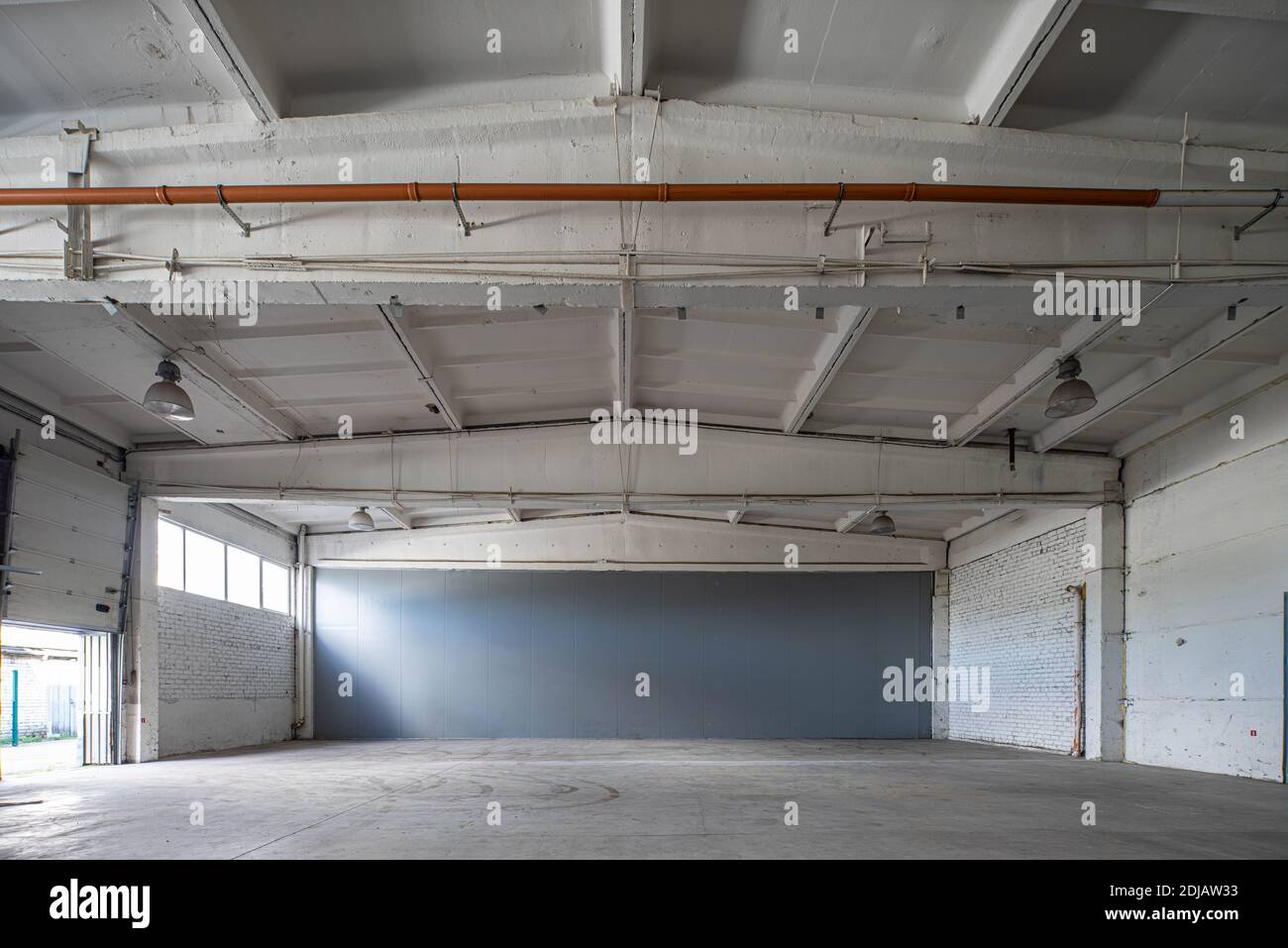 Modern interior of huge empty concrete industrial warehouse. White ...