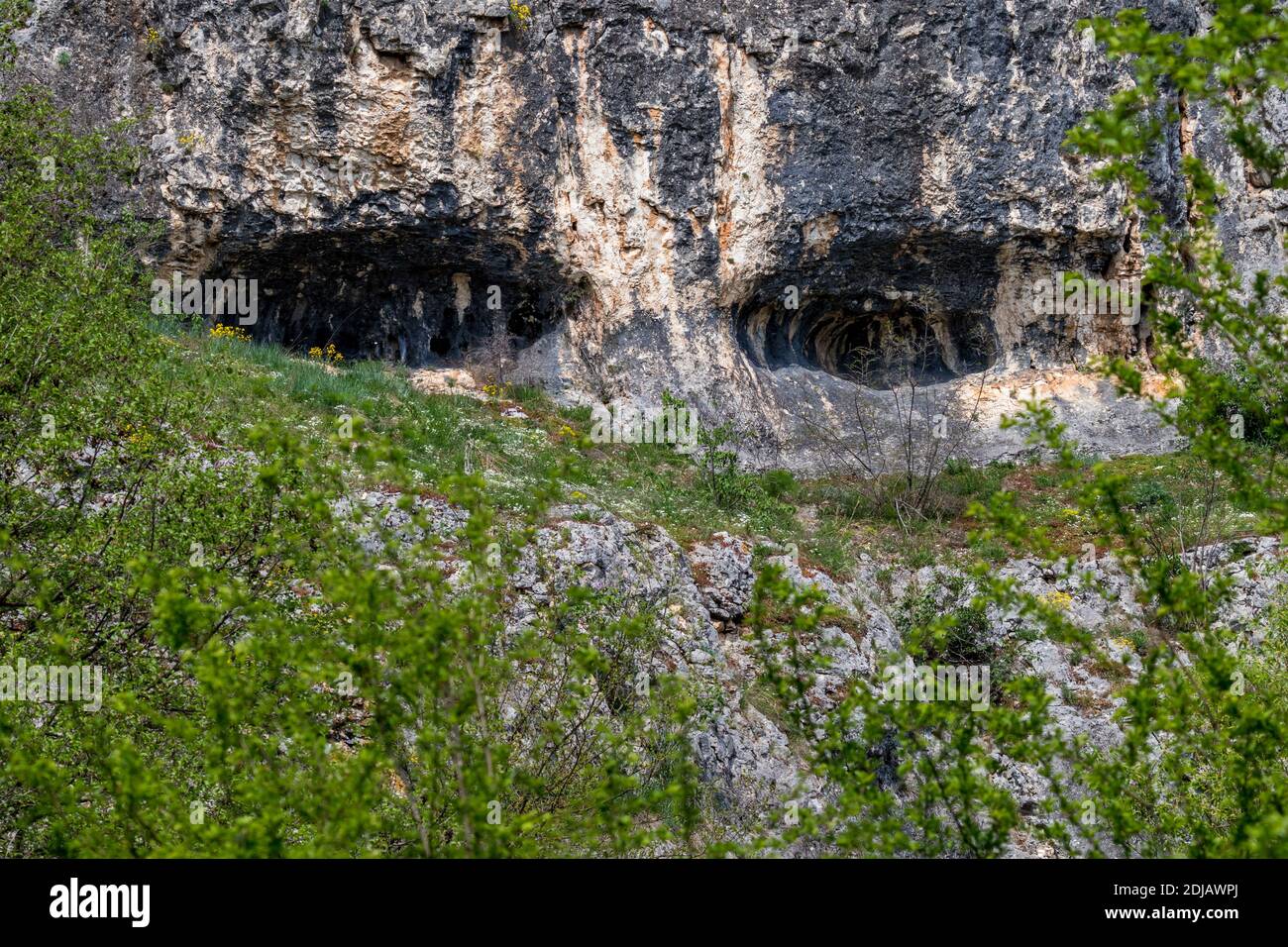 Karst caves front view, having the shape of two huge black eyes near ...