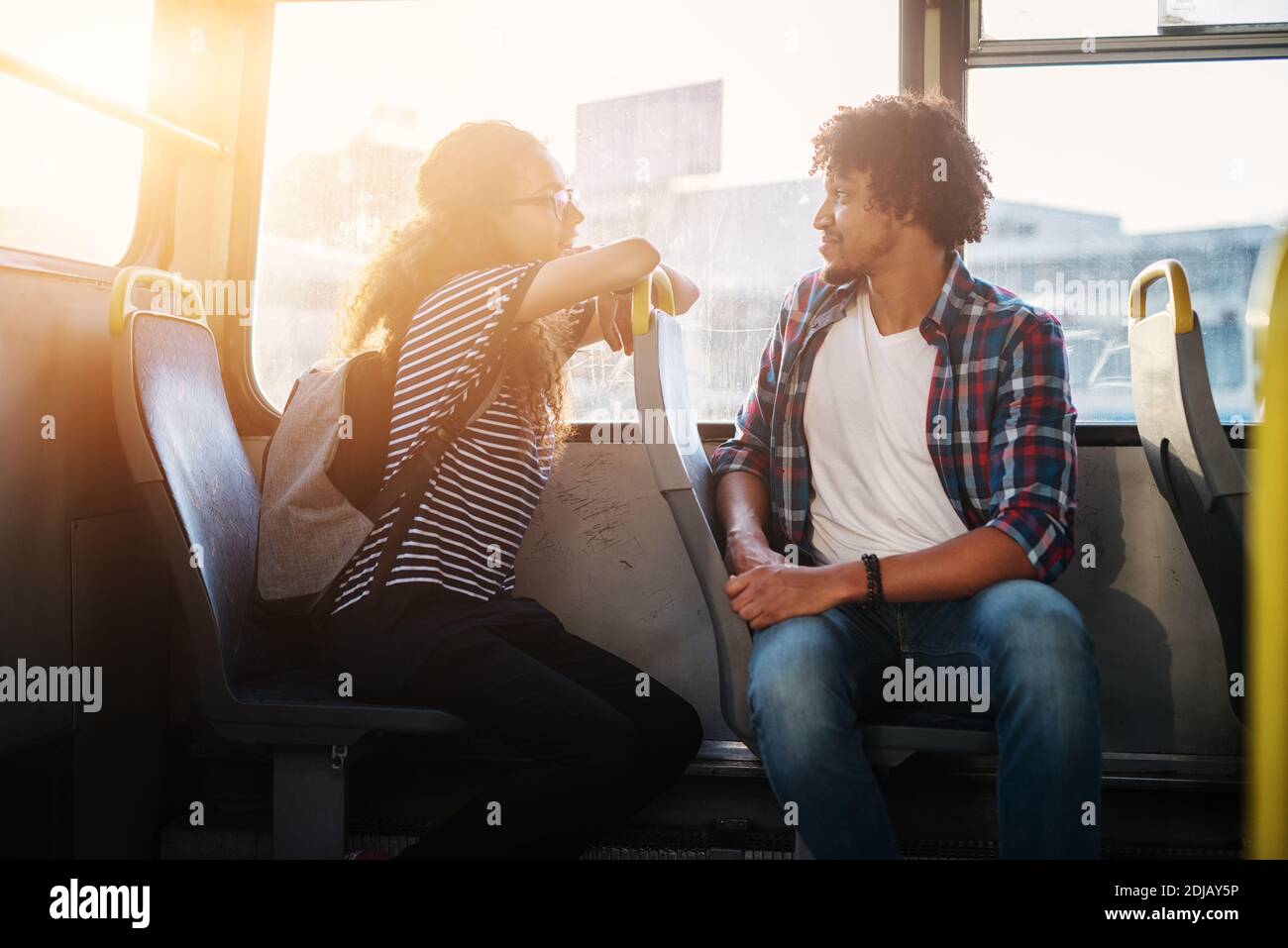 Young beautiful girl is sitting in a bus leaning against the seat of ...