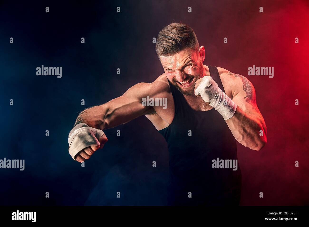Sportsman muay thai boxer fighting on black background with smoke ...