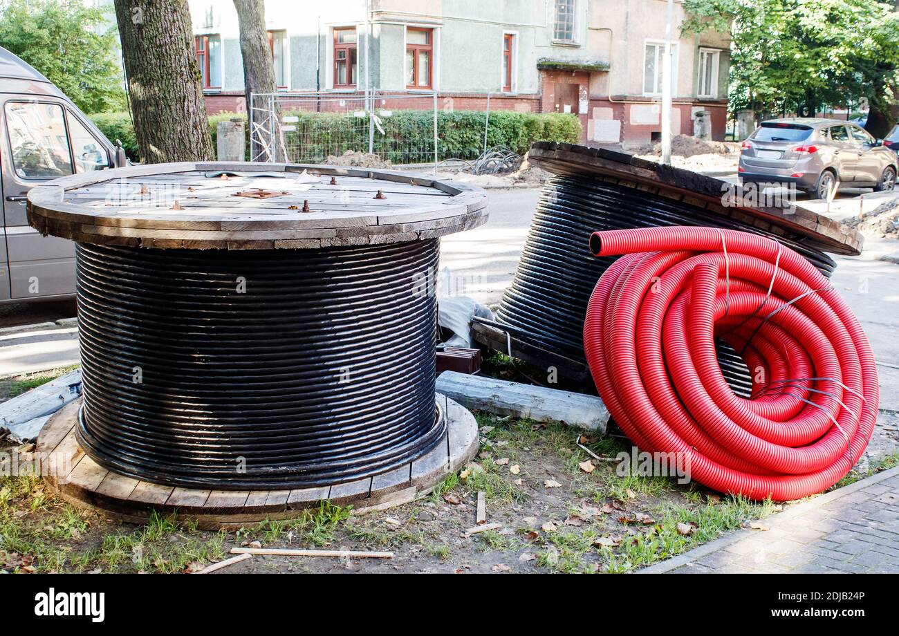 large wooden spools with cable prepared for laying outdoor on sunny ...