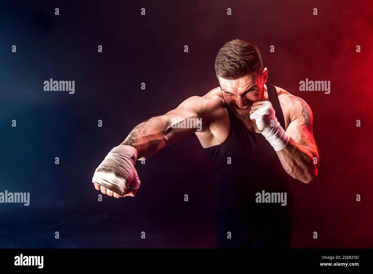 Sportsman muay thai boxer fighting on black background with smoke ...