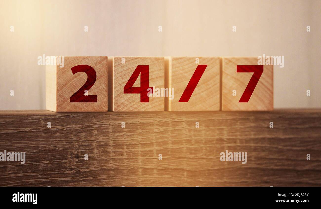 24 for 7 text on cubes on wooden background. Support clients concept ...
