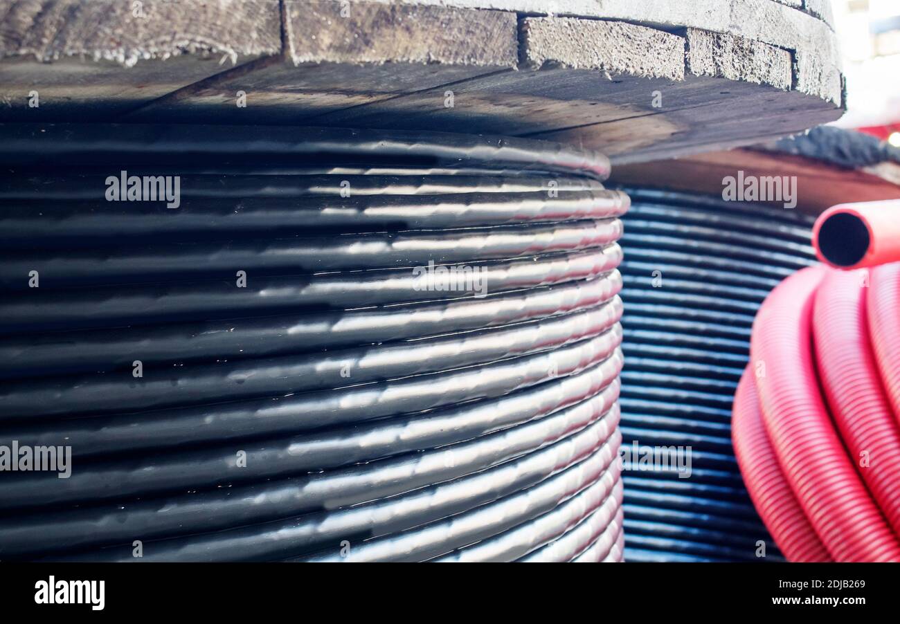 large wooden spools with cable prepared for laying outdoor on sunny ...