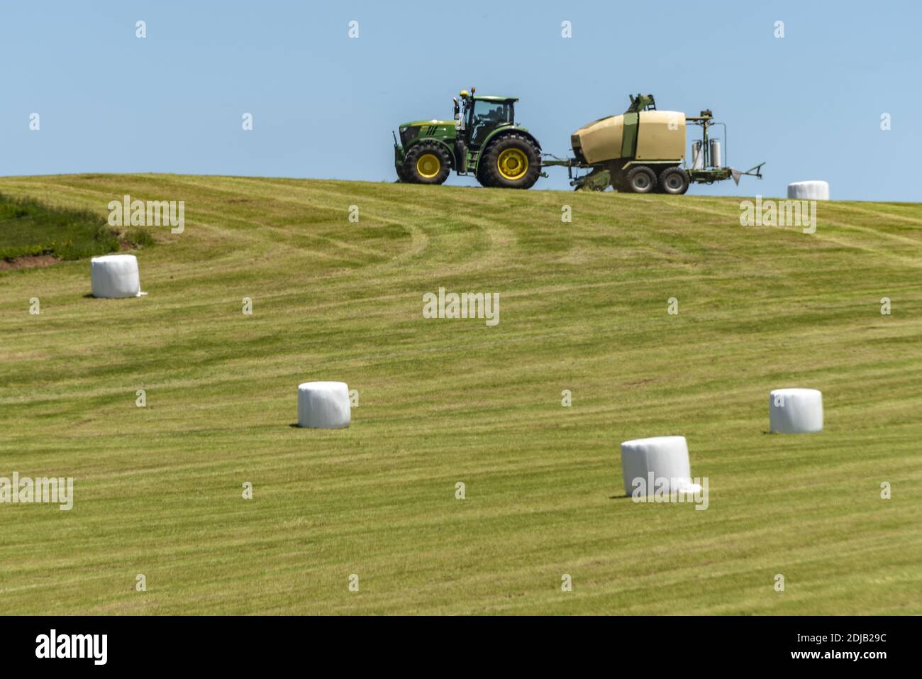 A beautiful view of a tractor on an agricultural farm on a sunny day ...