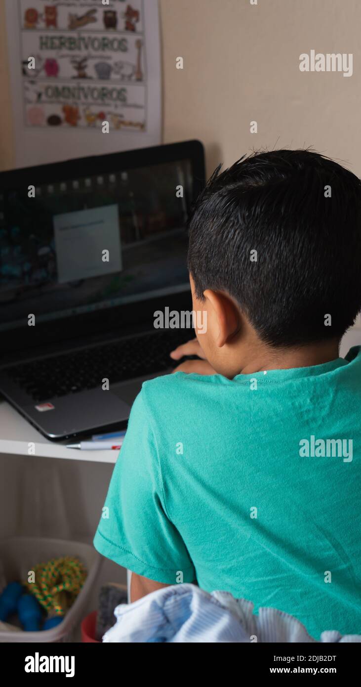 A vertical high angle shot of a child receiving virtual classes Stock ...