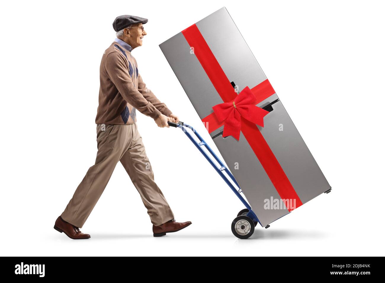 Elderly man pushing a fridge with a red bow on a hand truck isolated on ...